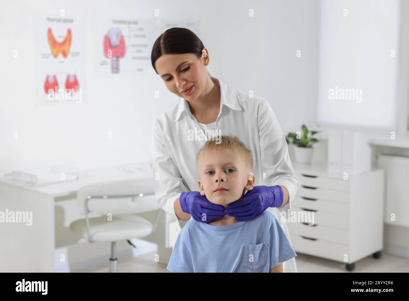Endocrinologist examining boy's thyroid gland at hospital Stock Photo ...