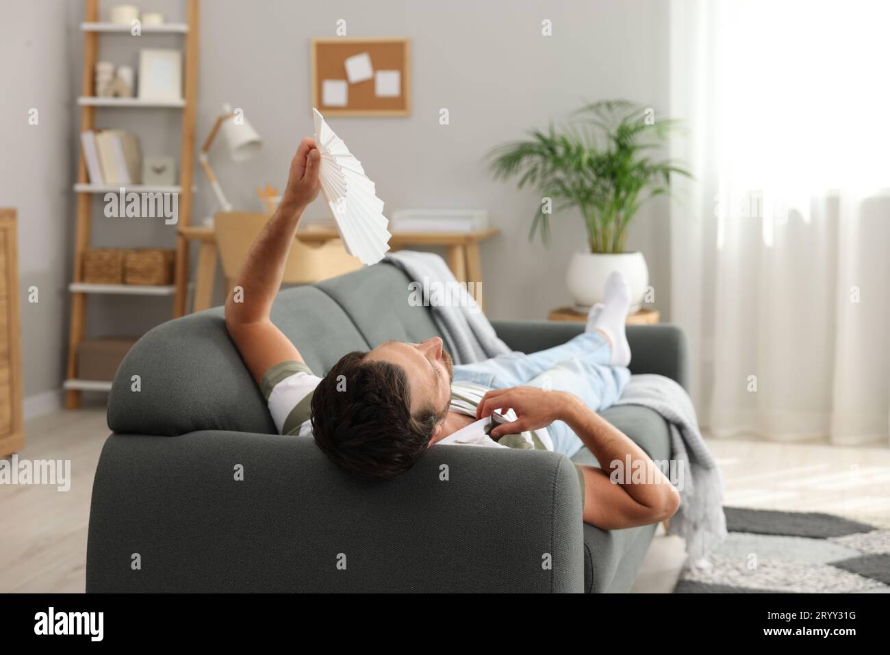 Fanning himself fan hi-res stock photography and images - Alamy