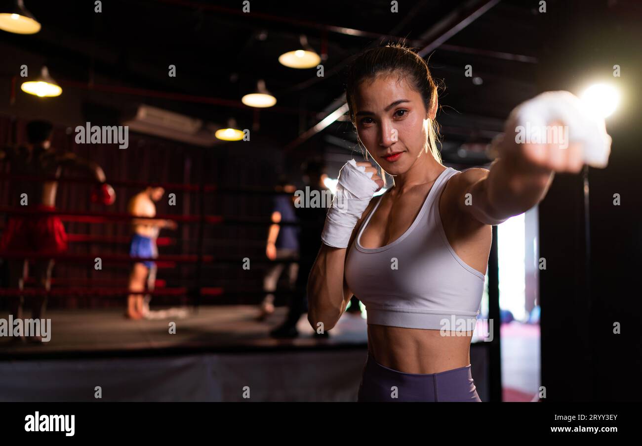 Portrait of woman learning Muay Thai to build up the strength of the ...