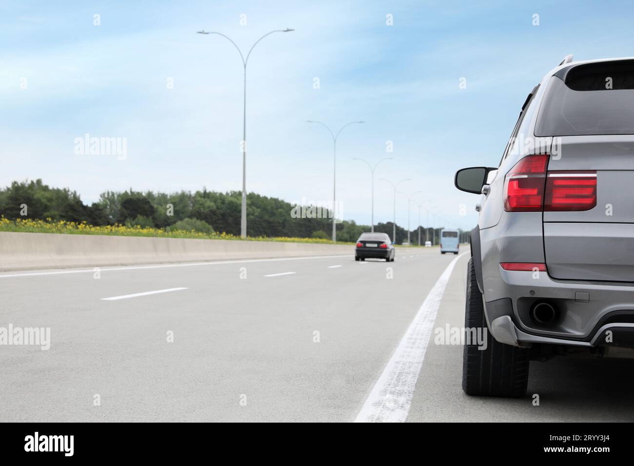 Grey modern car parked on asphalt road Stock Photo - Alamy