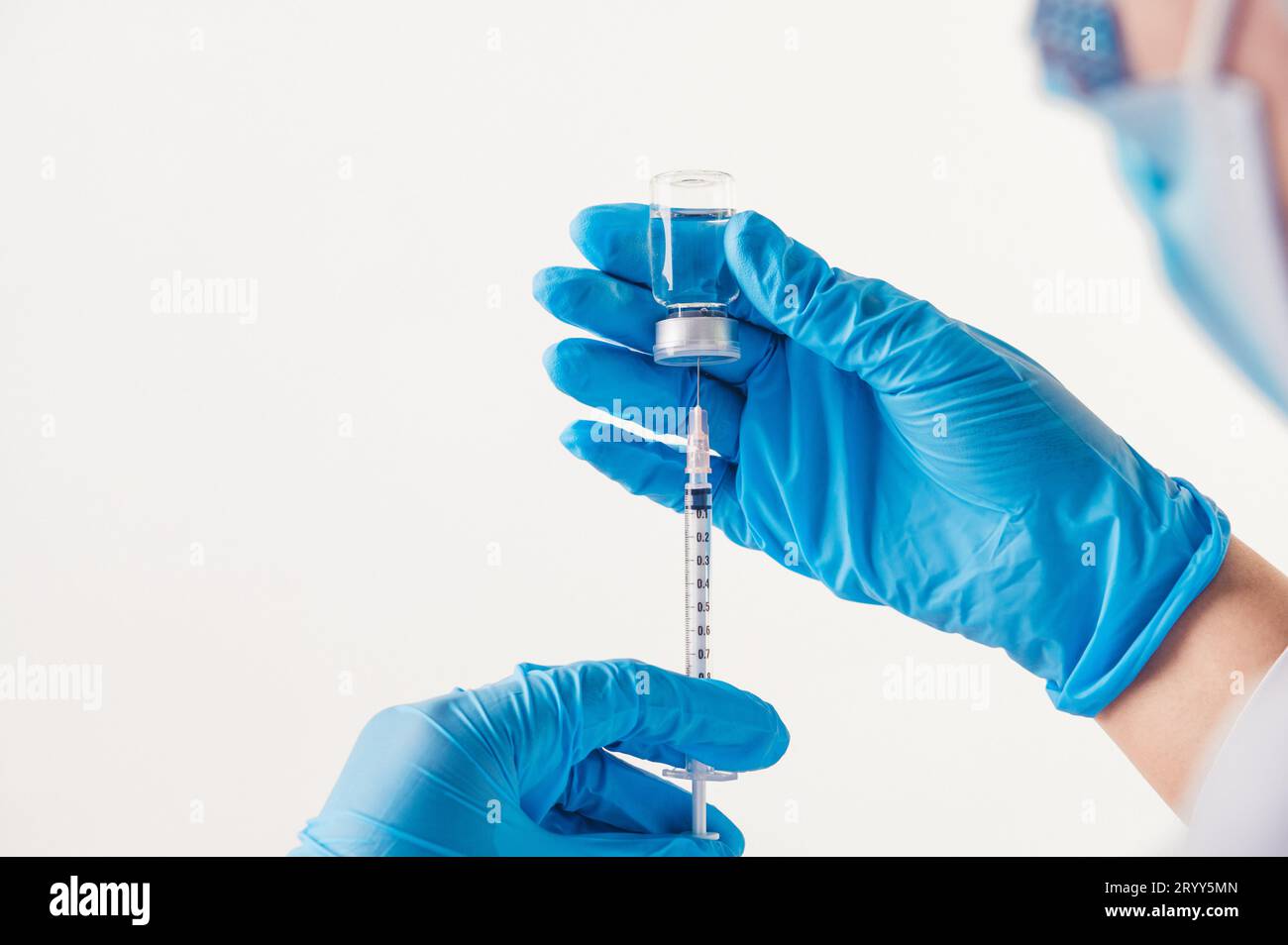 Closeup vial and needle of covid-19 vaccine in hand of scientist doctor ...