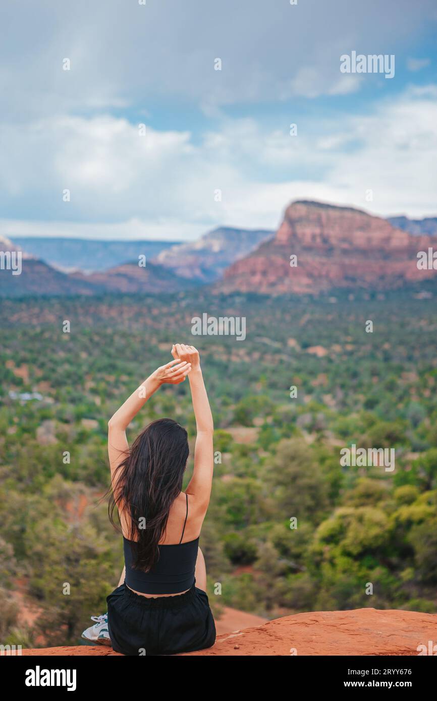 Woman enjoys the view of the Sedona landscape from the top of the Bell ...