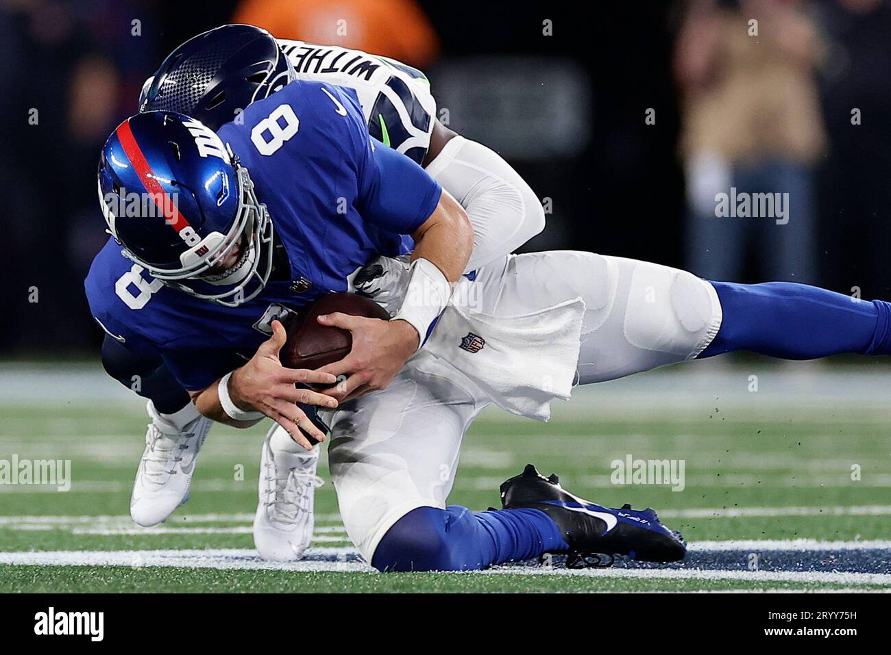 New York Giants quarterback Daniel Jones (8) is sacked by Seattle Seahawks cornerback Devon ...