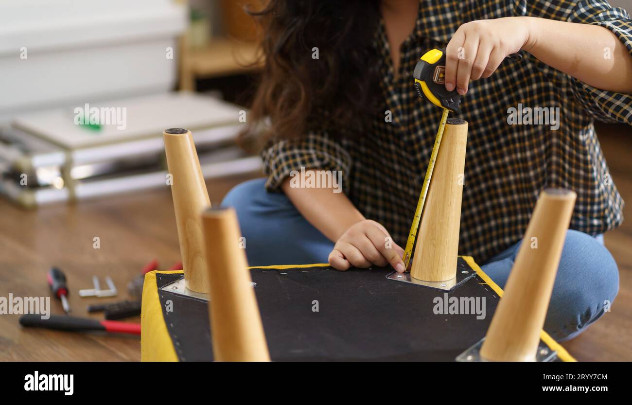 Asian Woman self repairs furniture renovation using equipment to diy ...