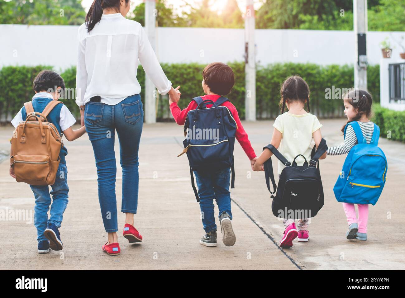 Back to school students mother group going school together. Parent send ...
