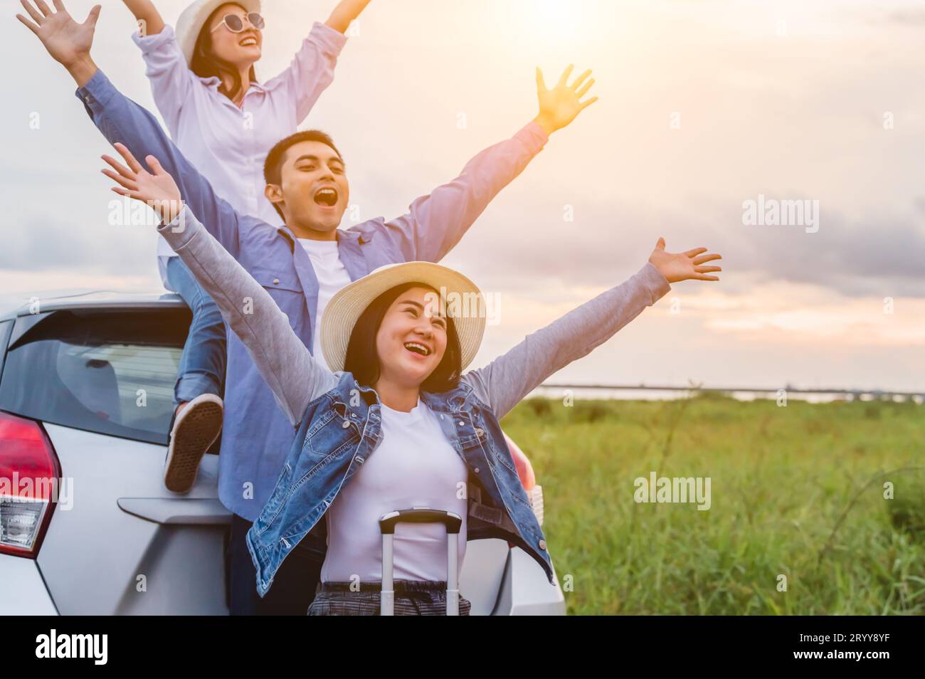 Happy Asian friends spread arms widely and breathed fresh air with ...