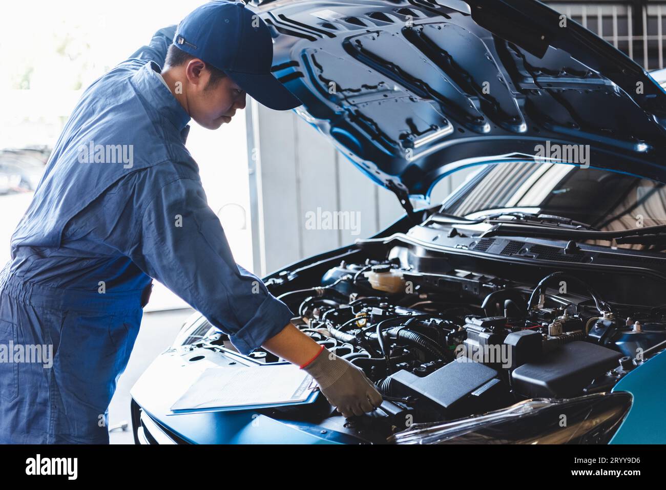 Car mechanic checking to maintenance vehicle by customer claim order in ...