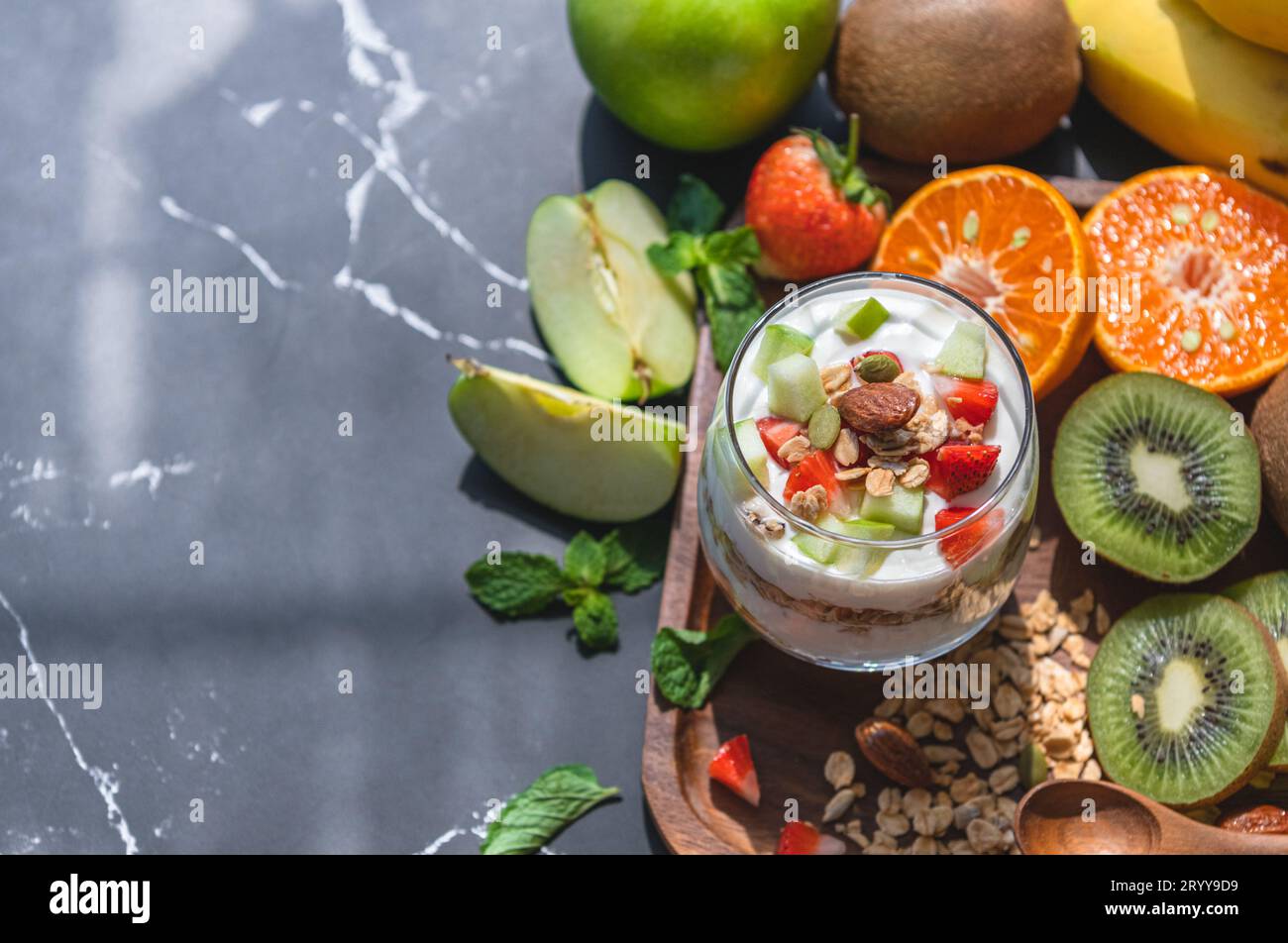 Closeup nutrition yogurt with many fruits on table. Food cuisine and ...