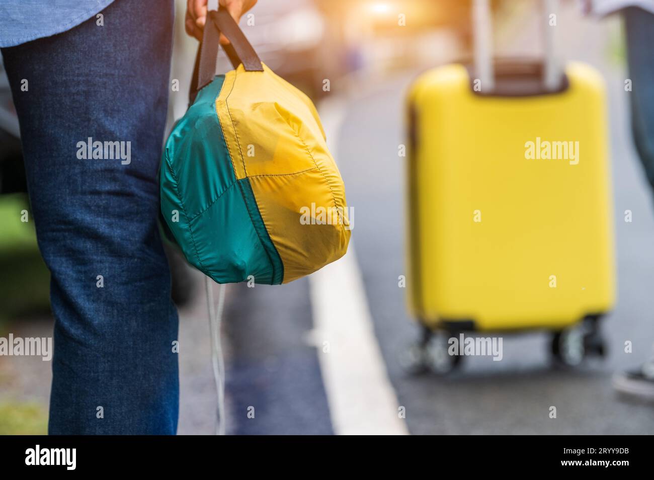 Closeup of tourist legs walking along road with bag during travel in ...