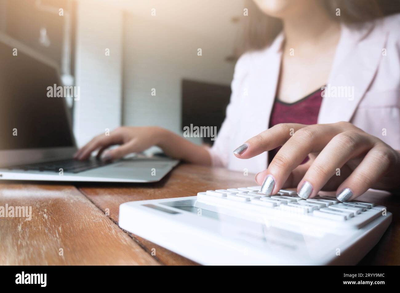 Business woman analyzing investment charts with calculator laptop ...