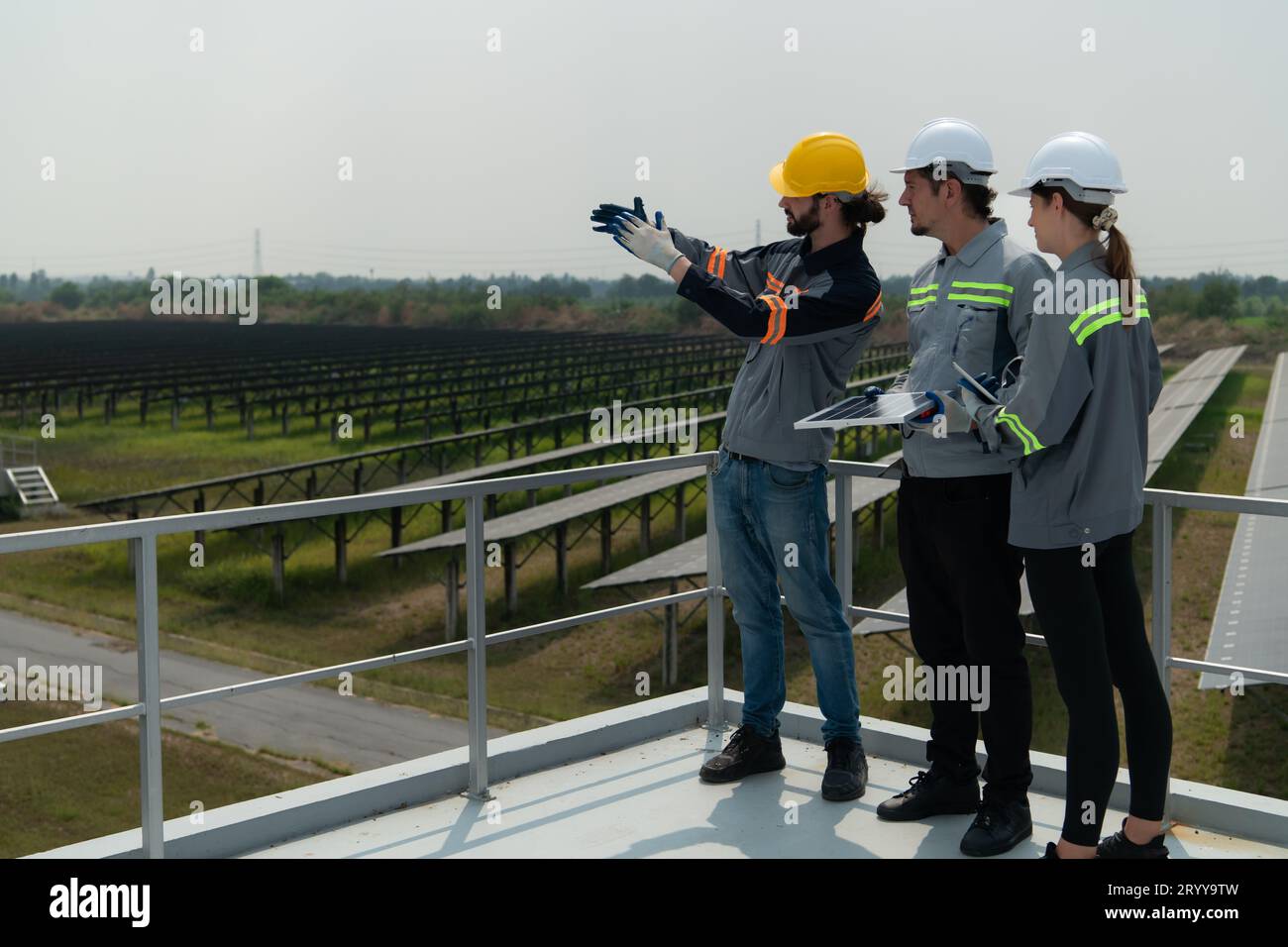 On the rooftop of a large solar energy storage station building A team ...