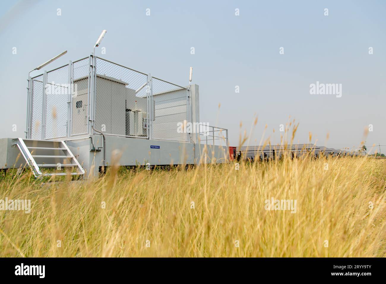 The field of solar panels with an energy storage station located in the ...