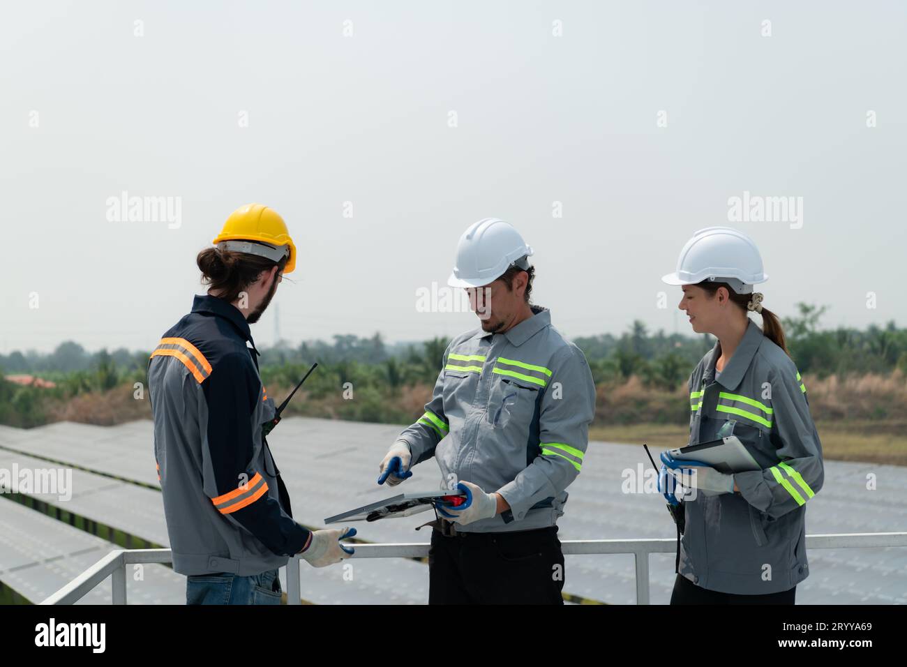On the rooftop of a large solar energy storage station building A team ...