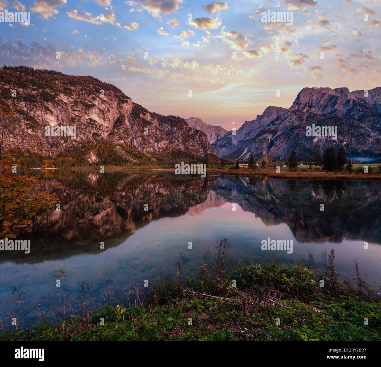 Autumn evening Alps mountain lake with clear transparent water and ...