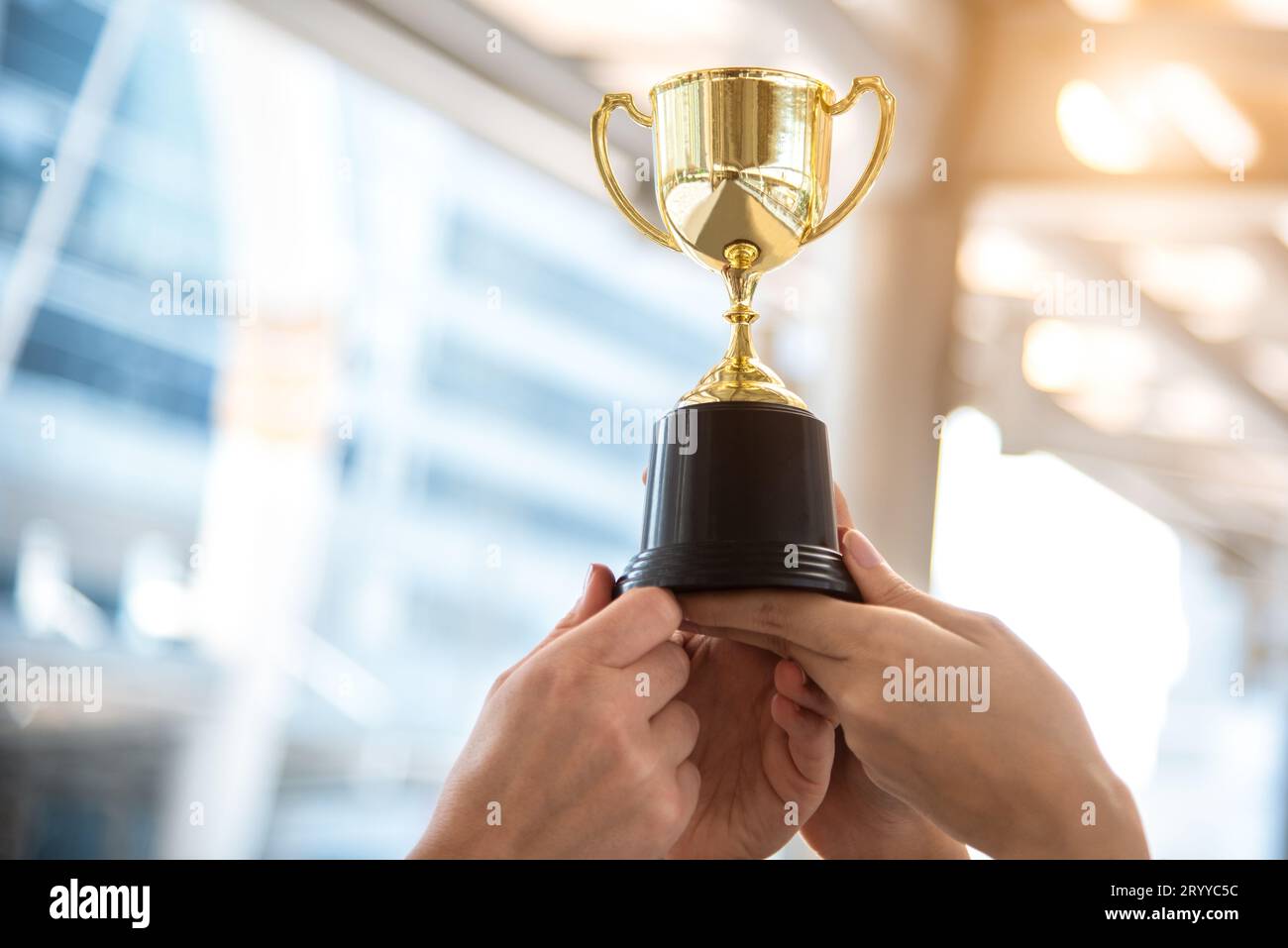 Champion golden trophy for winner with sport player hands in sport ...