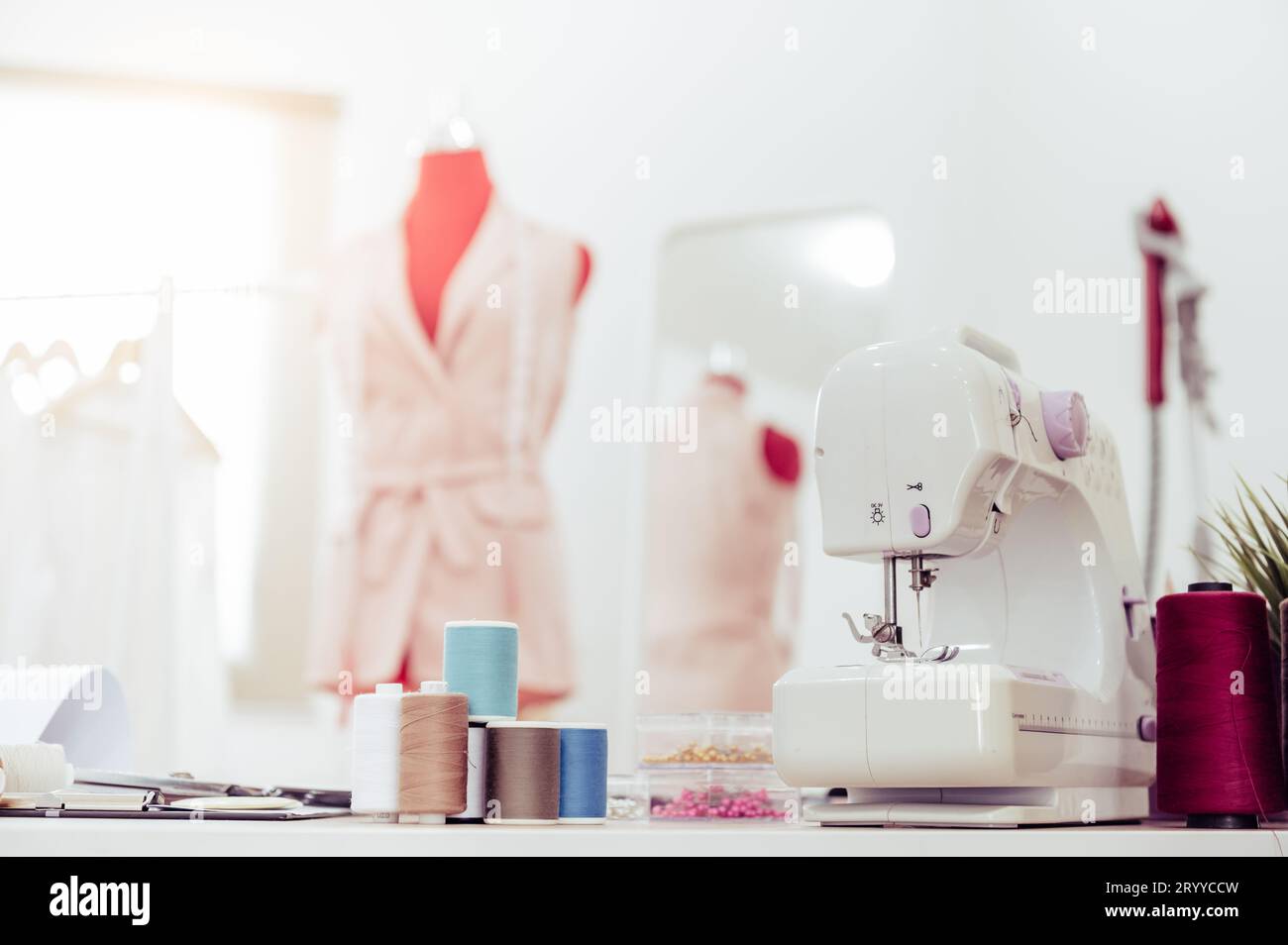 Closeup of sewing machine with fashion designer showroom studio ...