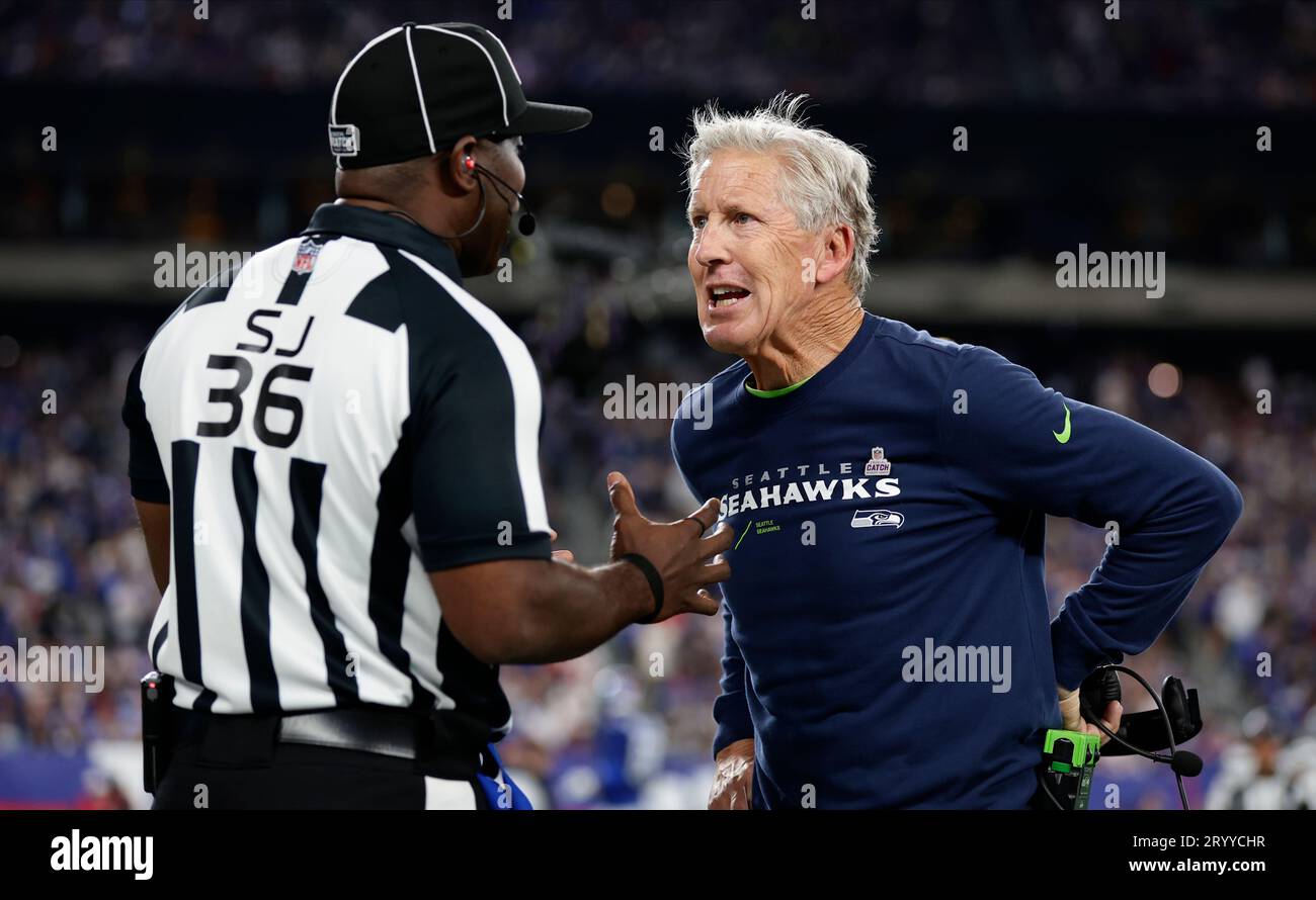 Seattle Seahawks head coach Pete Carroll talks with field judge Anthony ...