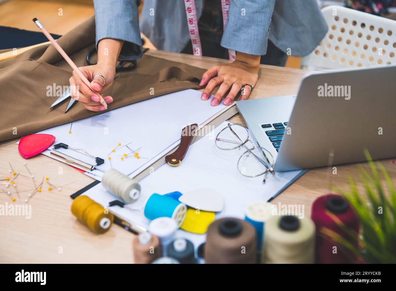 Closeup of attractive female fashion designer hand working in home ...
