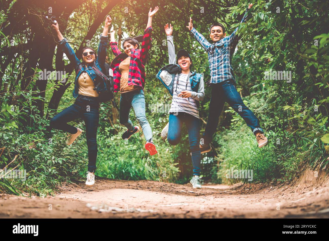 Group of happy Asian teenage adventure traveler trekkers group jumping ...