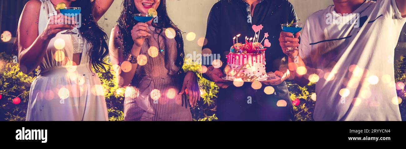 Closeup lower body friends group having outdoor birthday party at night ...