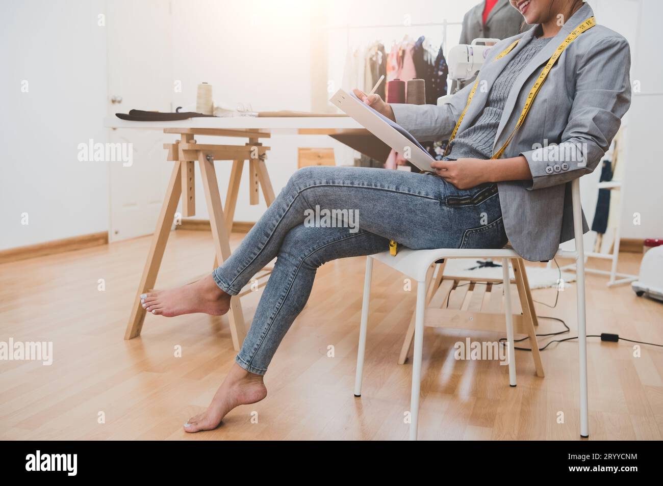 Attractive Asian female fashion designer working in home office ...