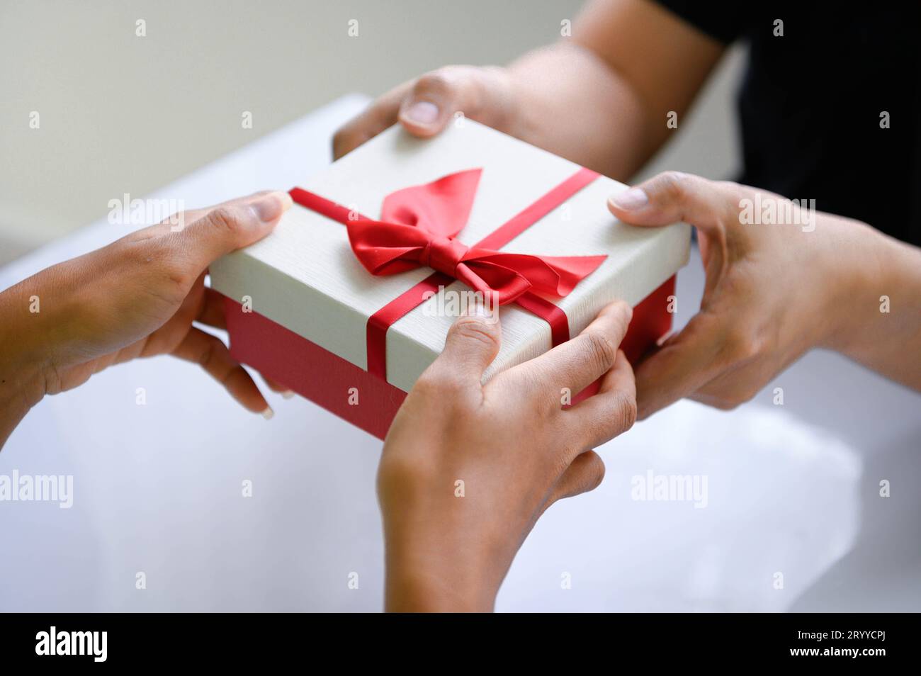 Closeup of hands giving gift box in Christmas day and new year festival ...