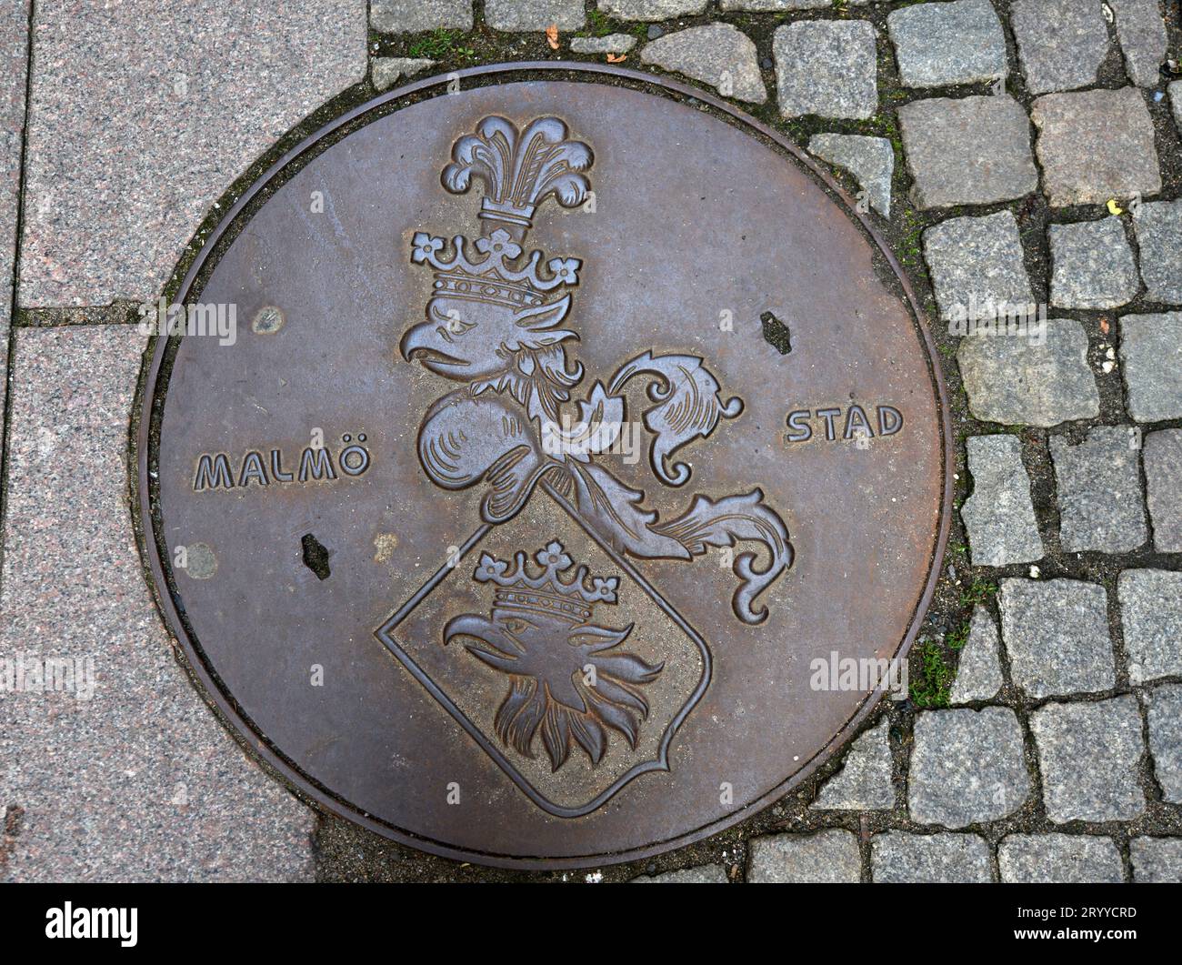 Malmö city manhole with the city's symbol Stock Photo - Alamy