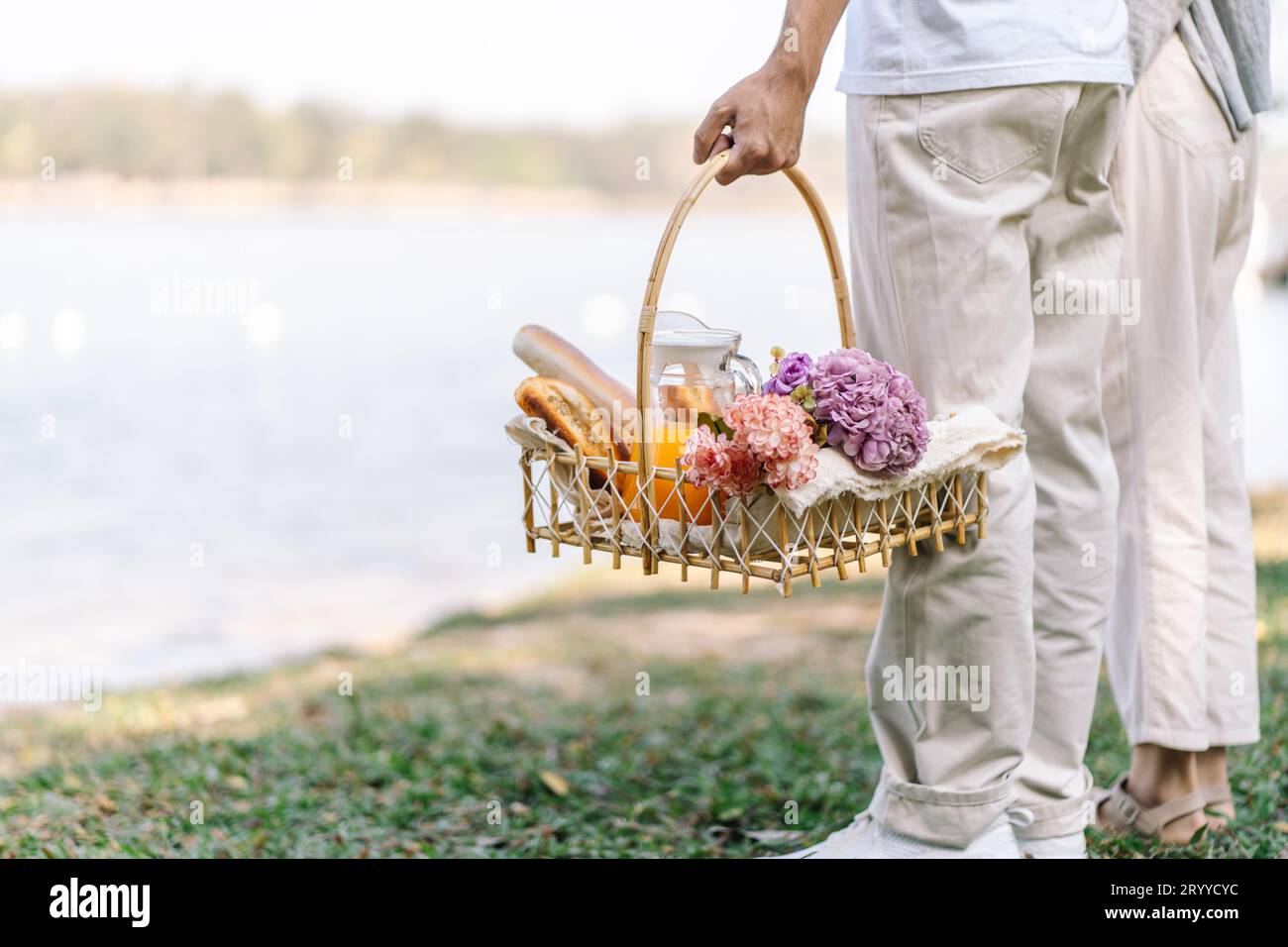 Couple walking in garden with picnic basket. in love couple is enjoying ...
