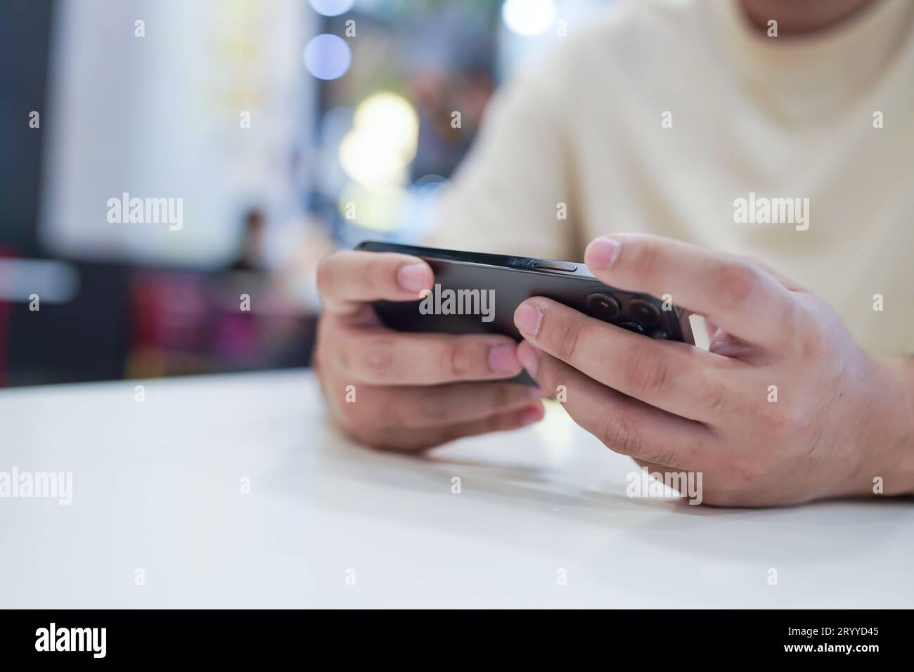 Man playing game on mobile phone. gamer boy playing video games holding ...