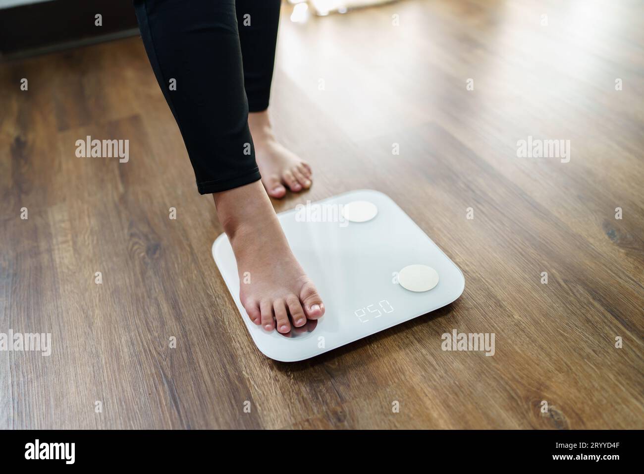Lose weight. Fat diet and scale feet standing on electronic scales for ...
