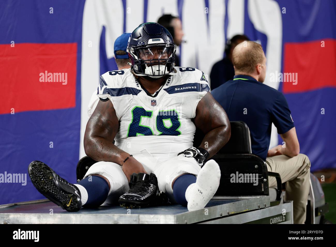 Seattle Seahawks guard Damien Lewis (68) rides a cart off the field ...