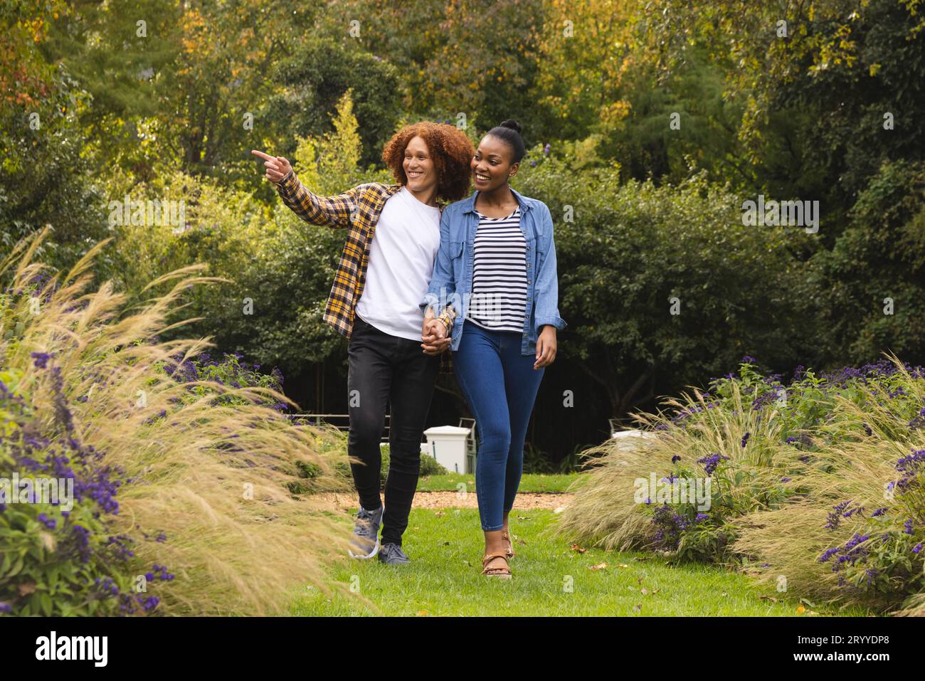 Diverse couple holding hands in hi-res stock photography and images - Alamy