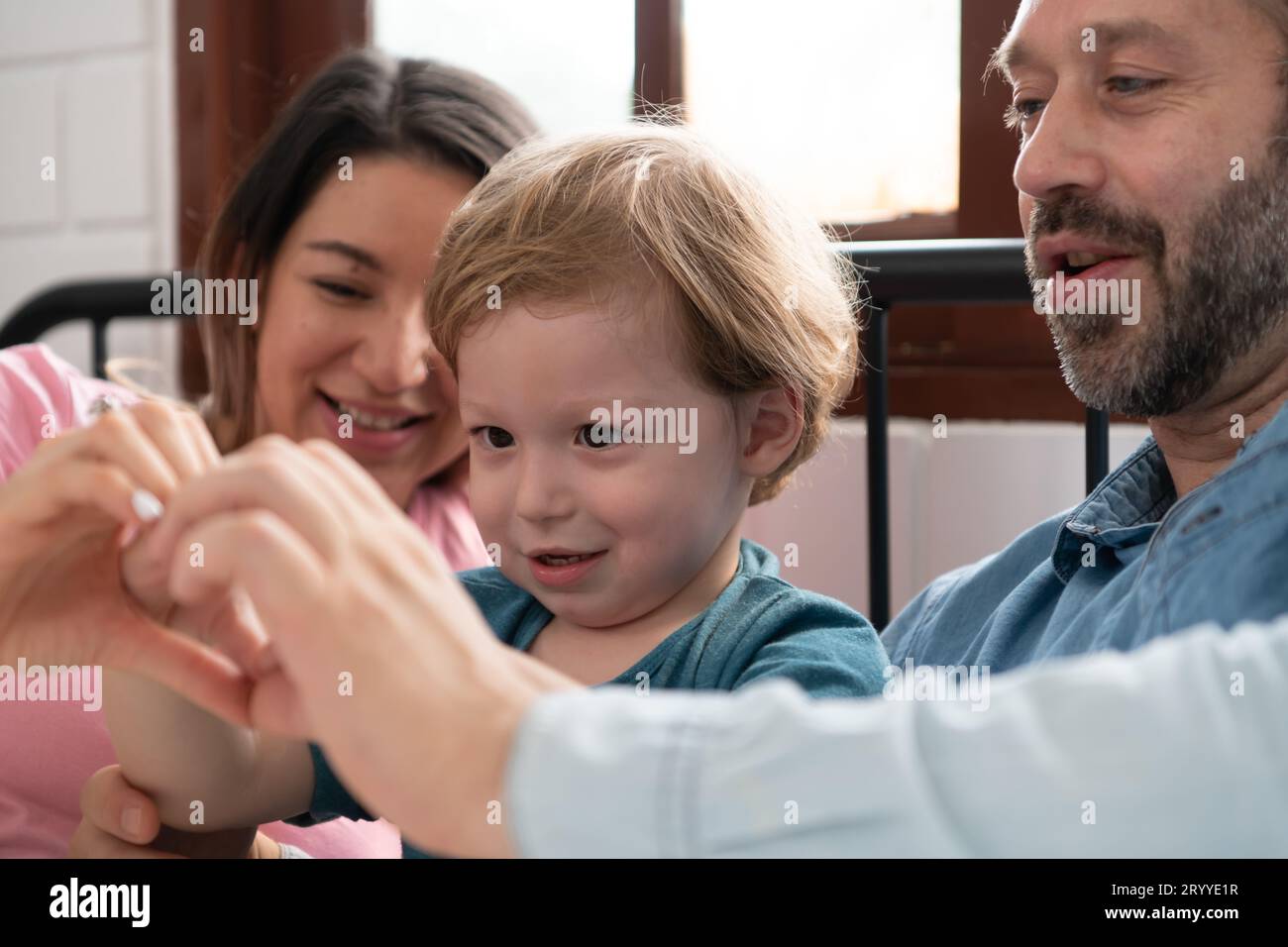 After the little boy wakes up from his nap, his father and mother ...
