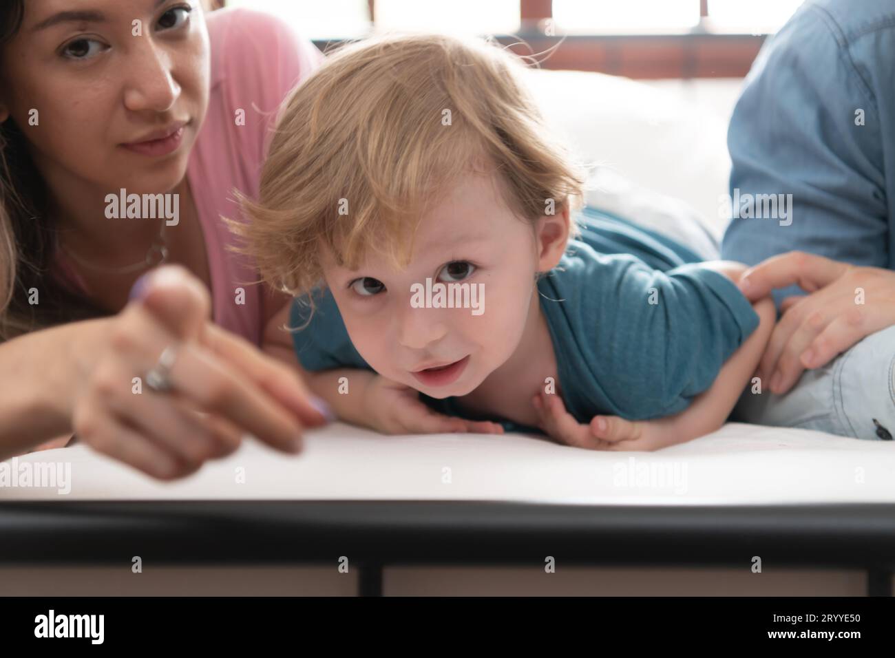 After the little boy wakes up from his nap, his father and mother ...
