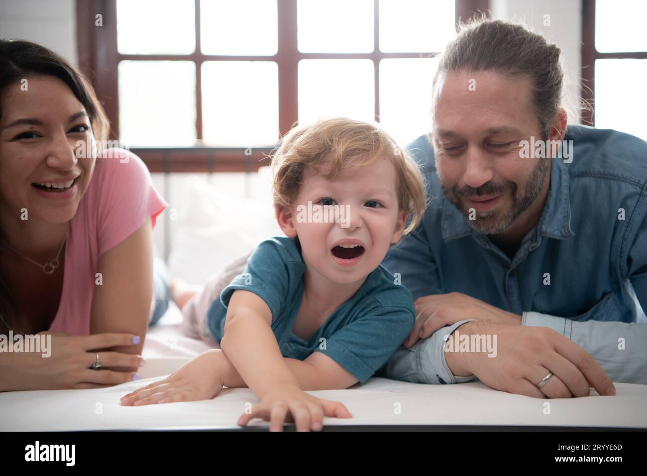 After the little boy wakes up from his nap, his father and mother ...