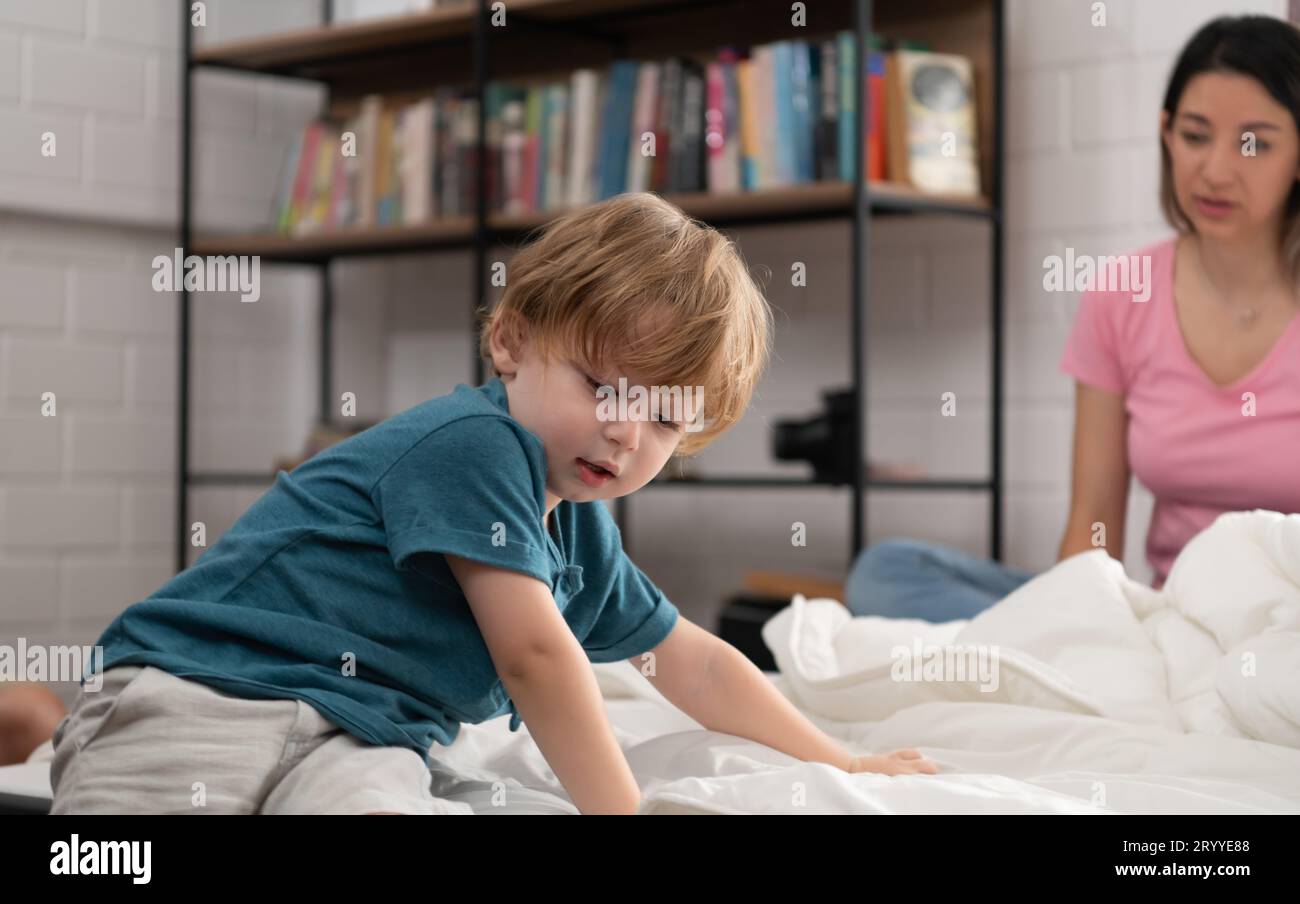 After the little boy wakes up from his nap, his father and mother ...