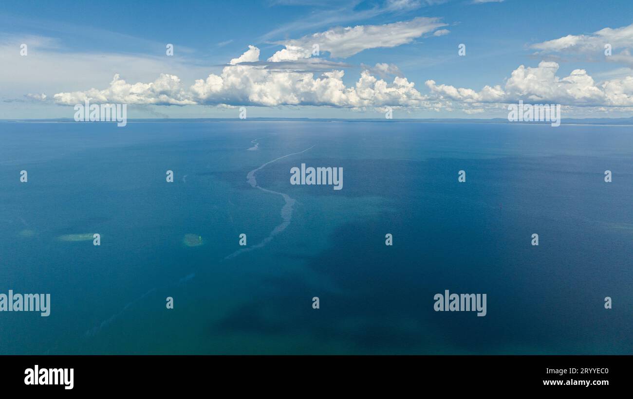 Surface of blue ocean with waves and blue sky with cloud. Borneo ...