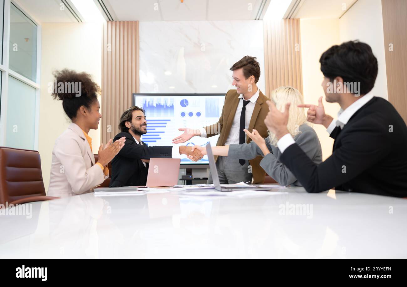 In the meeting room of an international business corporation, a diverse ...
