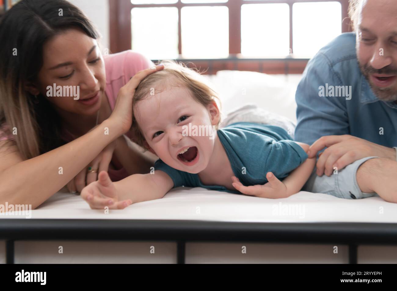 After the little boy wakes up from his nap, his father and mother ...