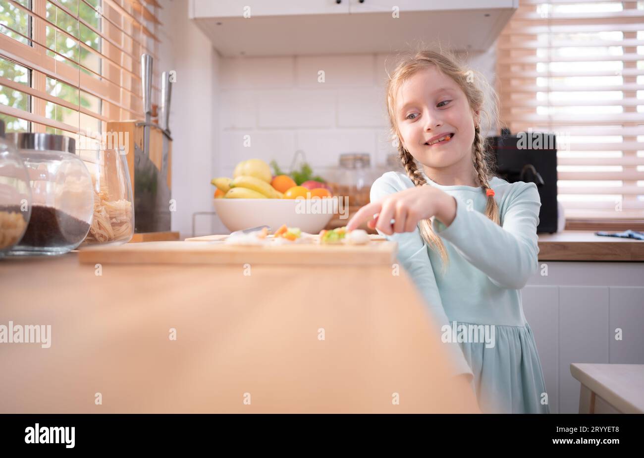 Granddaughter of grandparents in a kitchen with plenty of natural light ...