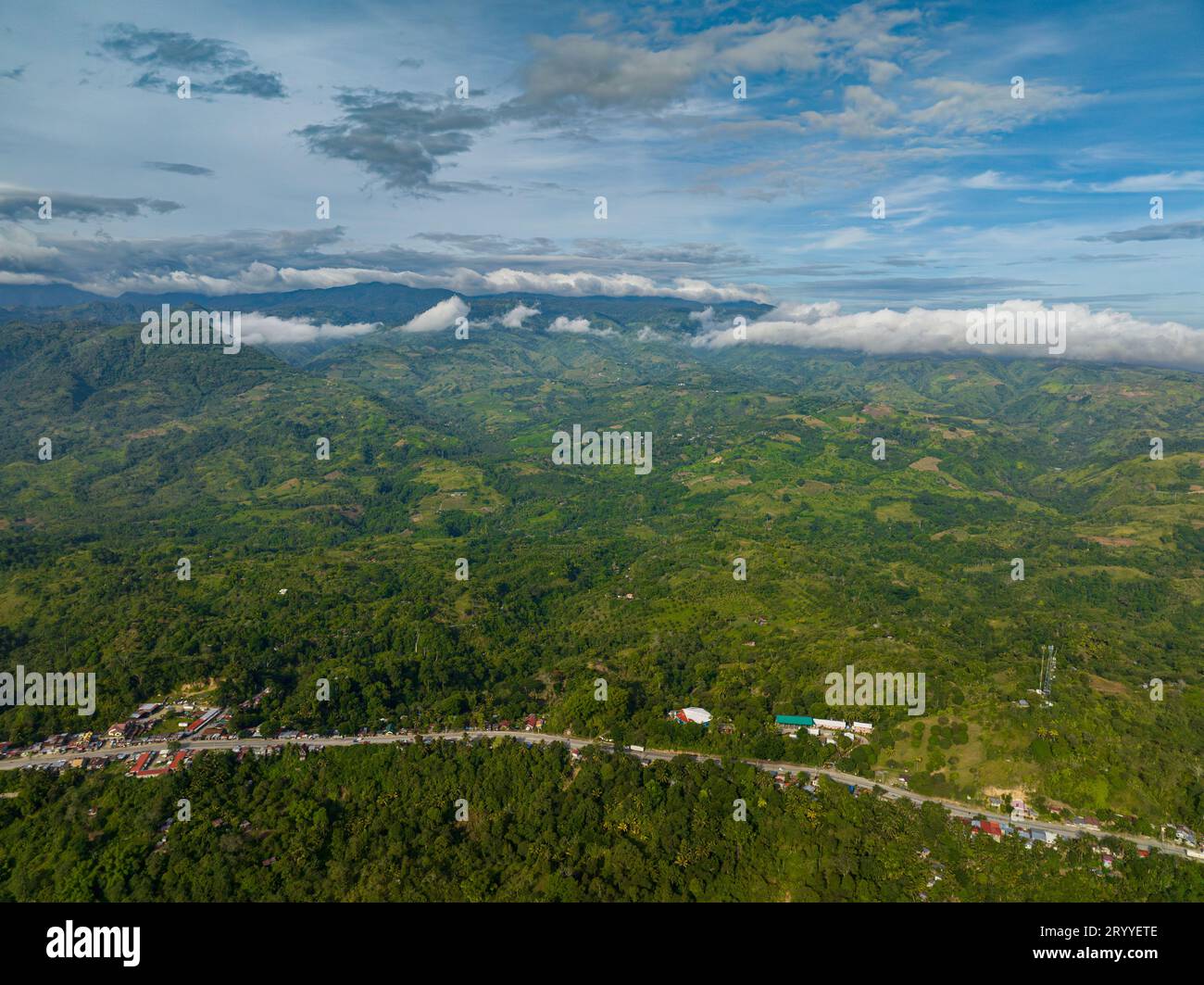 Tropical mountain range and mountain slopes with rainforest. Blue sky ...