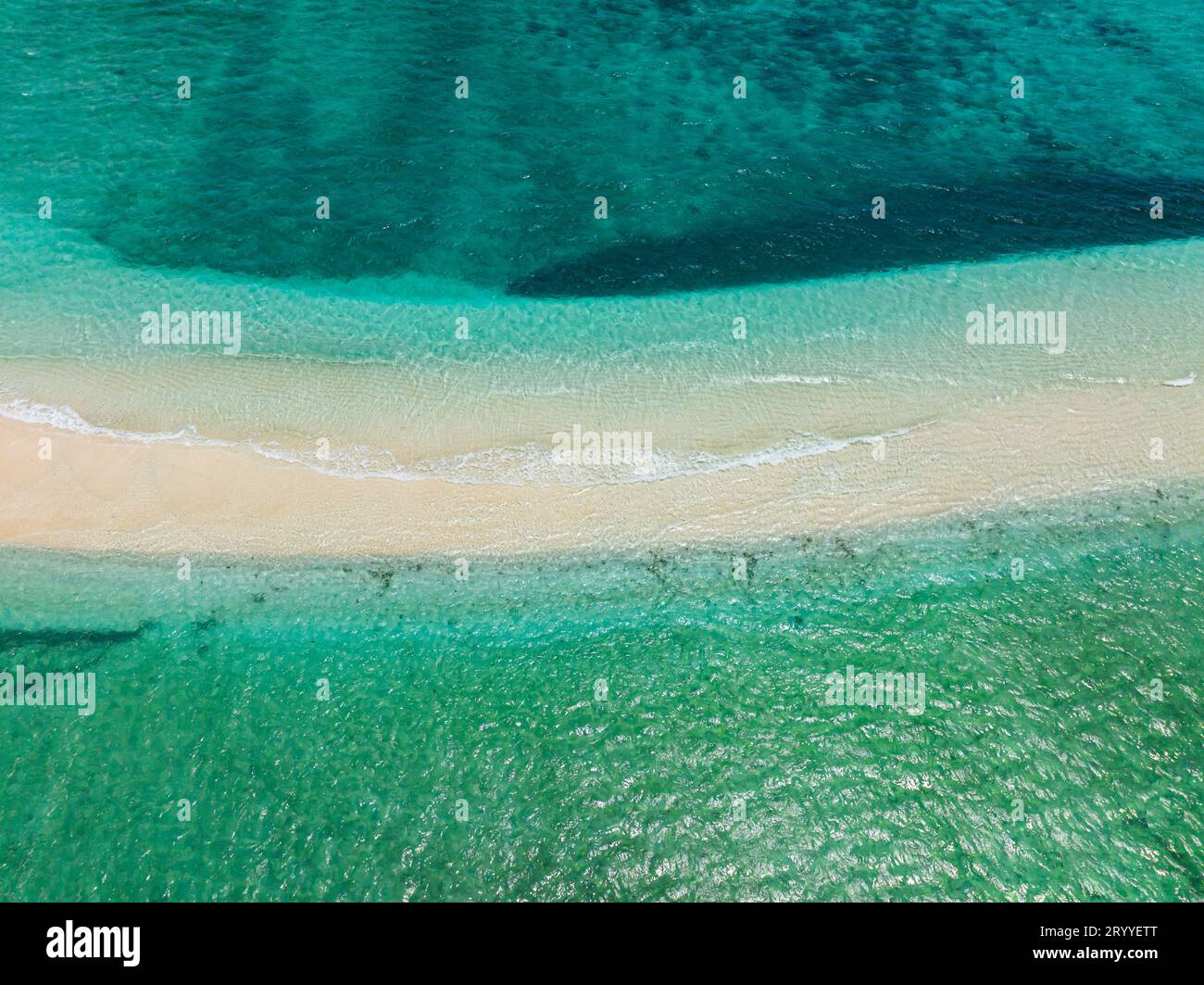 Flying over the sea with white sandbar and transparent ocean waves ...