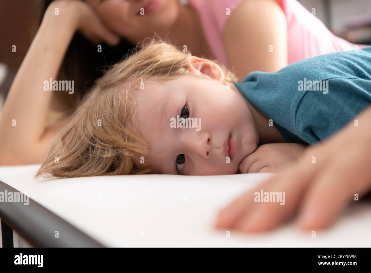 After the little boy wakes up from his nap, his father and mother ...