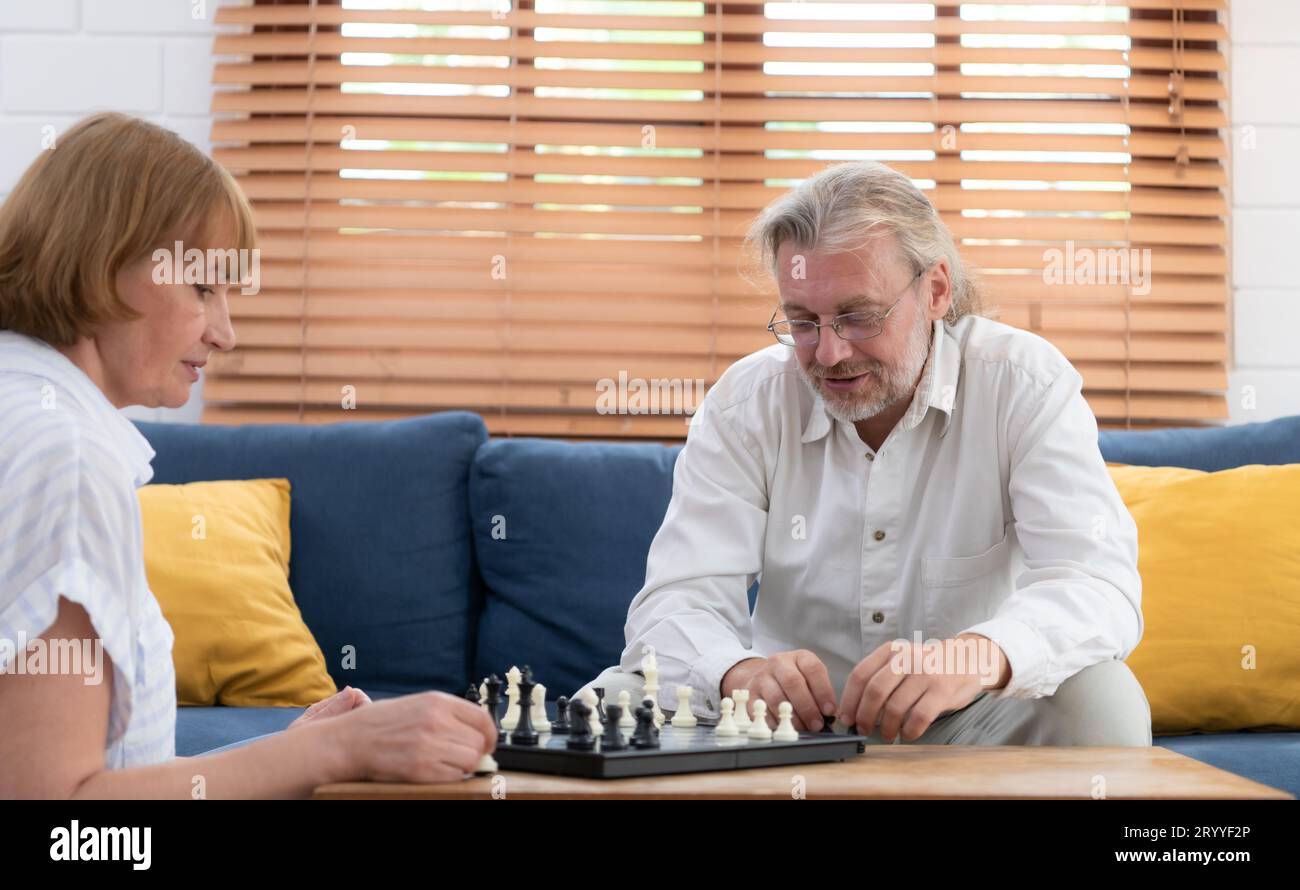 In the living room of the house, an elderly couple sits and relaxes. to ...
