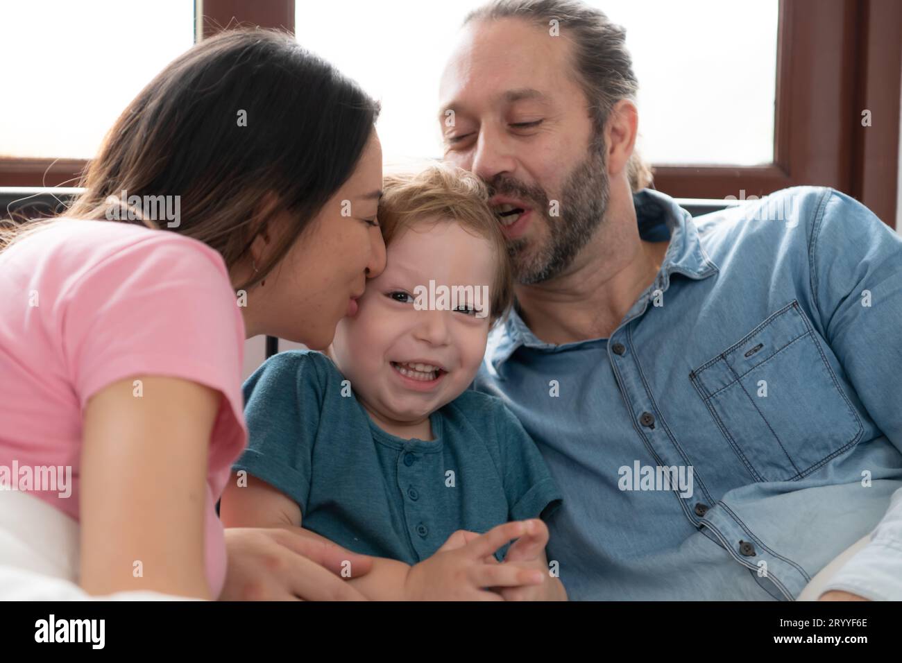 After the little boy wakes up from his nap, his father and mother ...