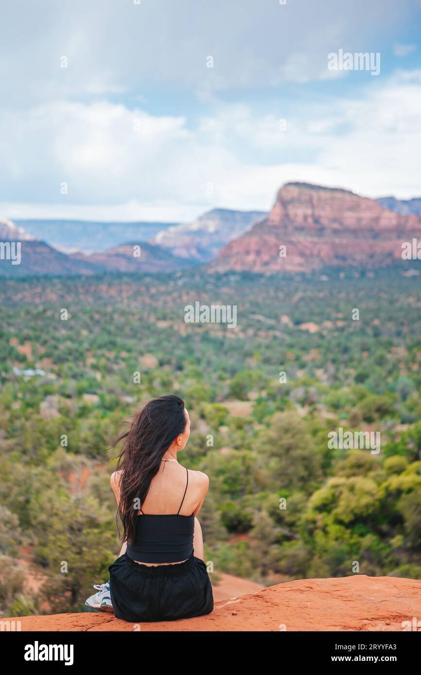 Woman enjoys the view of the Sedona landscape from the top of the Bell ...