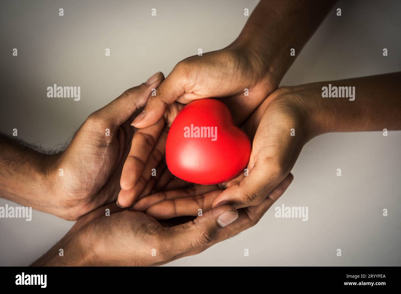 Helping hand of heart donor for patient in heart disease. Man give red ...