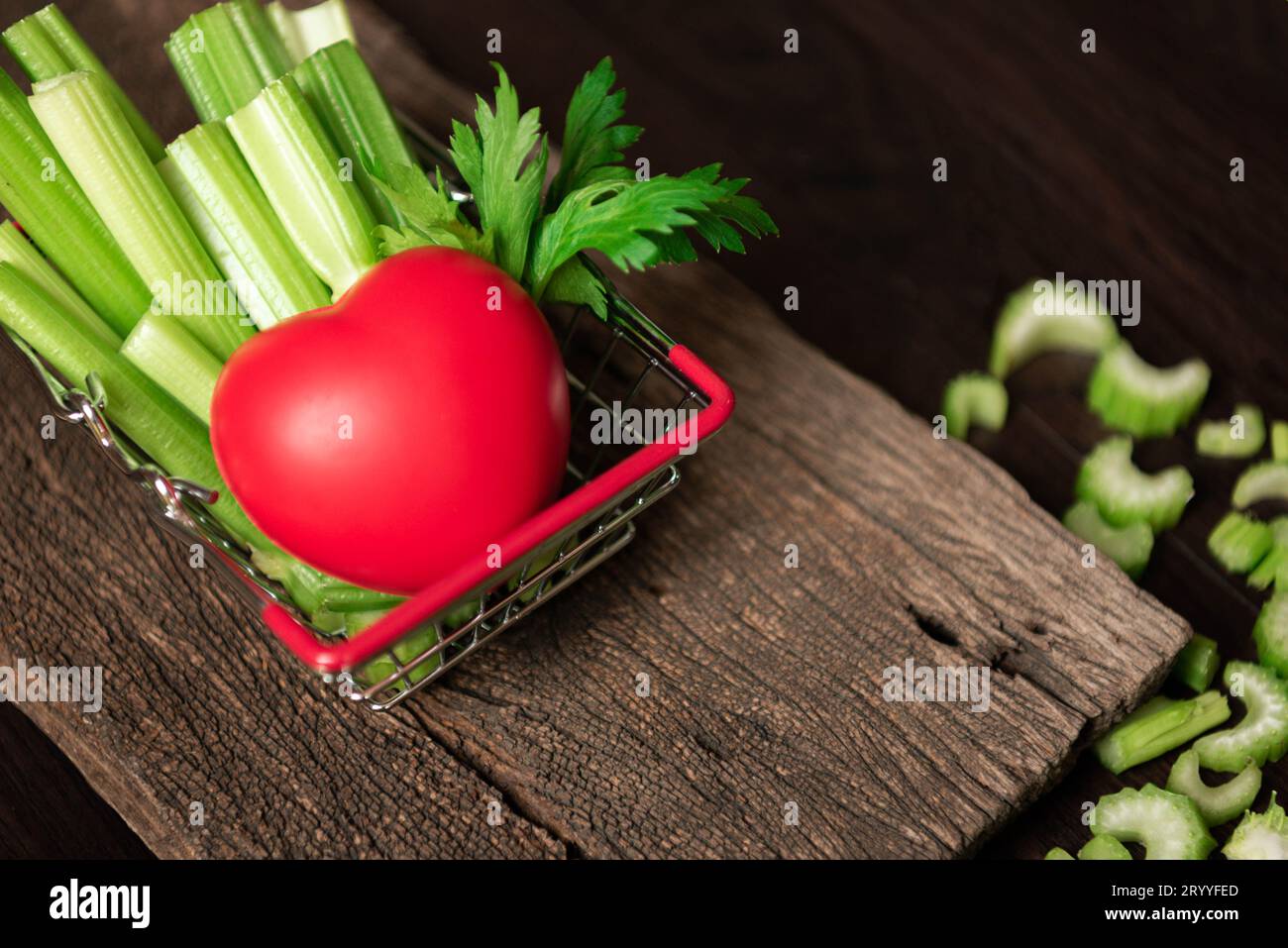 Bunch of fresh celery stalk in shopping basket with leaves and red ...