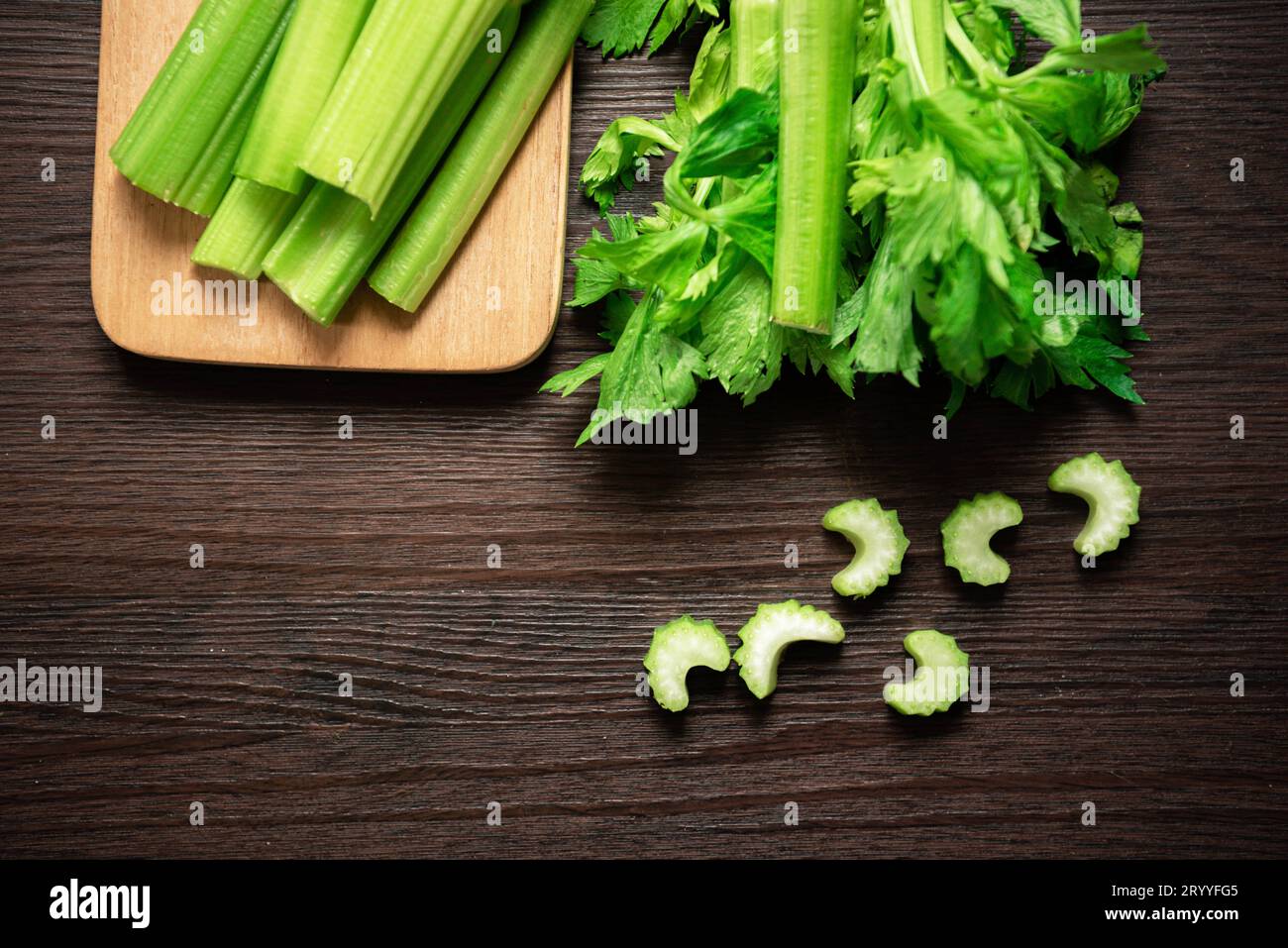Top view of bunch of fresh sliced celery stalk on wooden table with ...