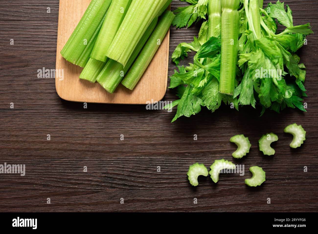 Top view of bunch of fresh sliced celery stalk on wooden table with ...
